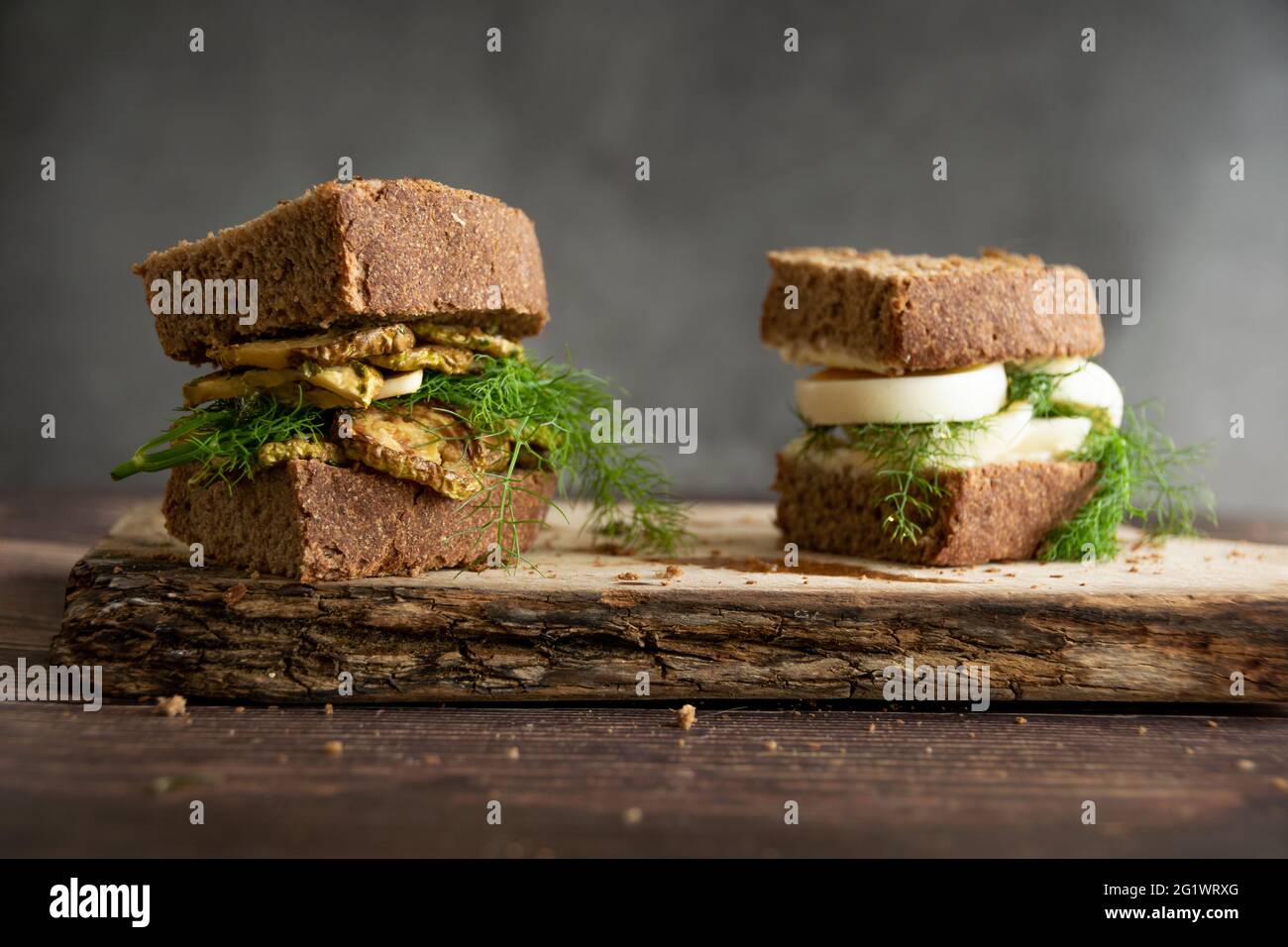 Homemade sandwiches with whole wheat bread, cream goat cheese, eggs ...