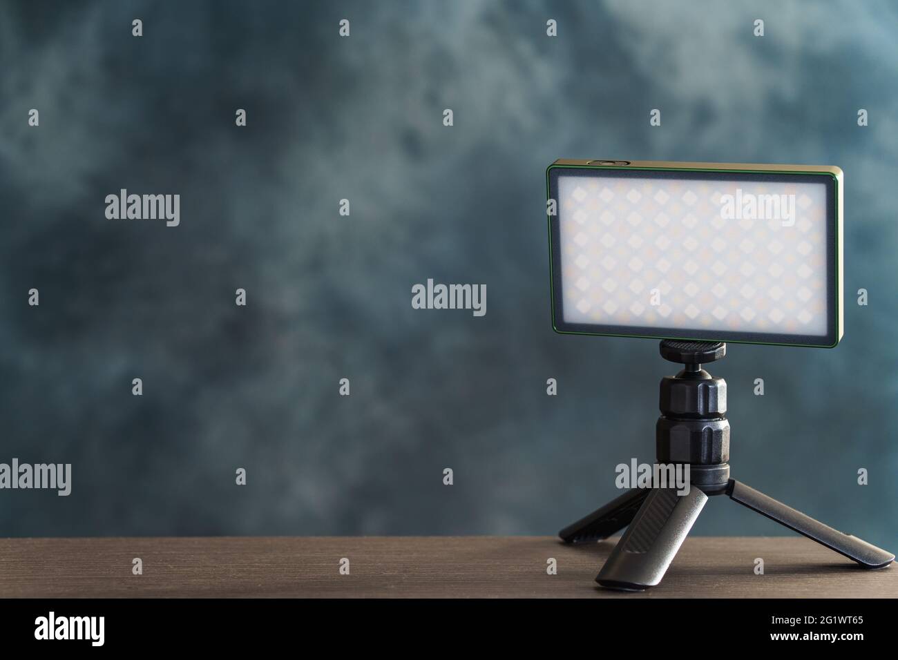 Mini LED light for videography on tripod on shelf with copy space Stock ...