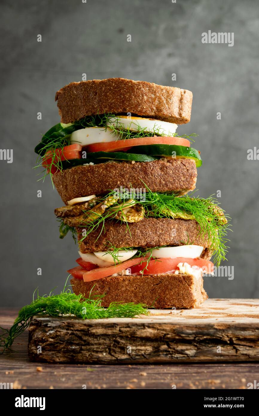 Homemade sandwiches with whole wheat bread, cream goat cheese, eggs ...
