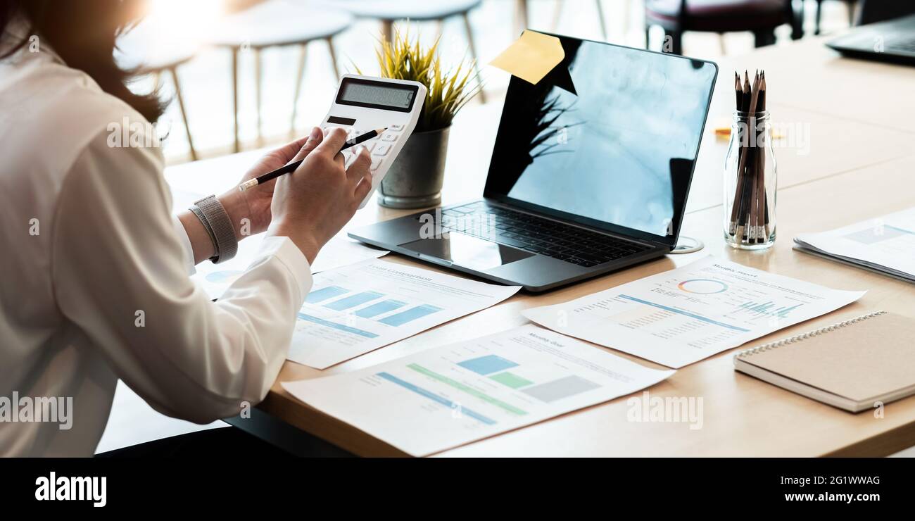businesswoman working on desk office with using a calculator to ...