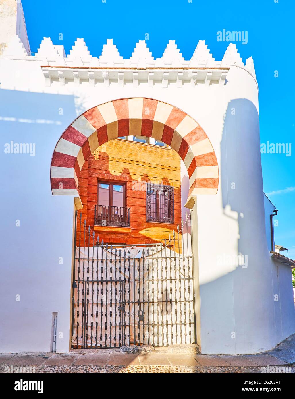 The medieval Mudejar gate of the mansion with traditional horseshoe ...