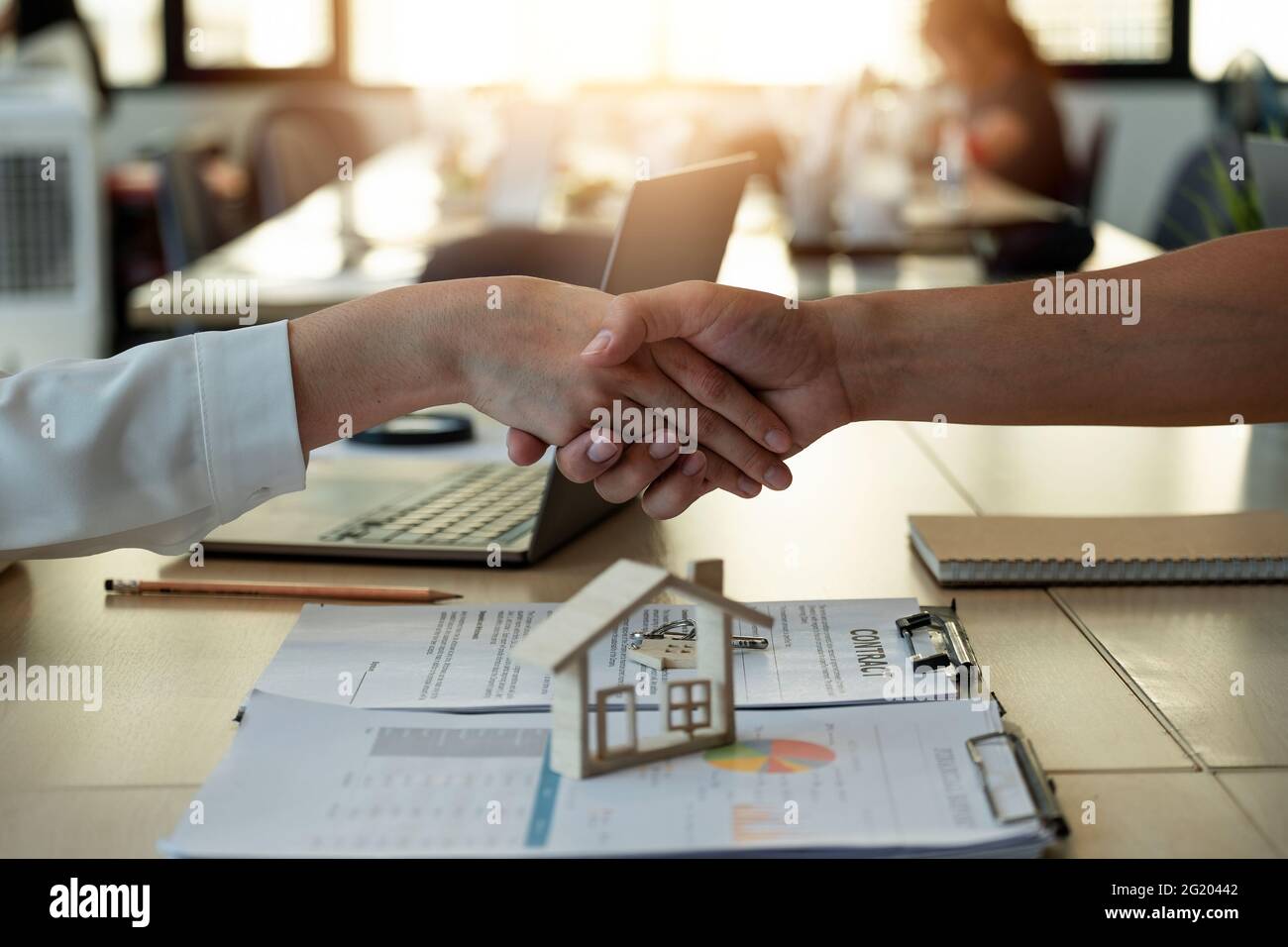 Handshake a successful real estate transaction in an office. Business ...