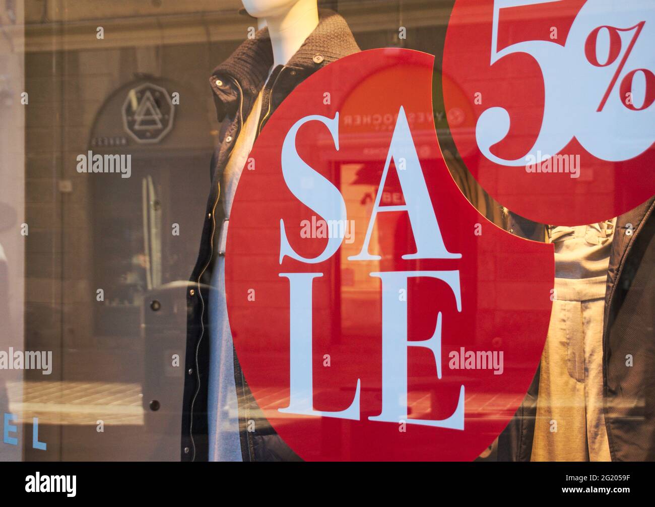 sale sign in clothing store window Stock Photo - Alamy