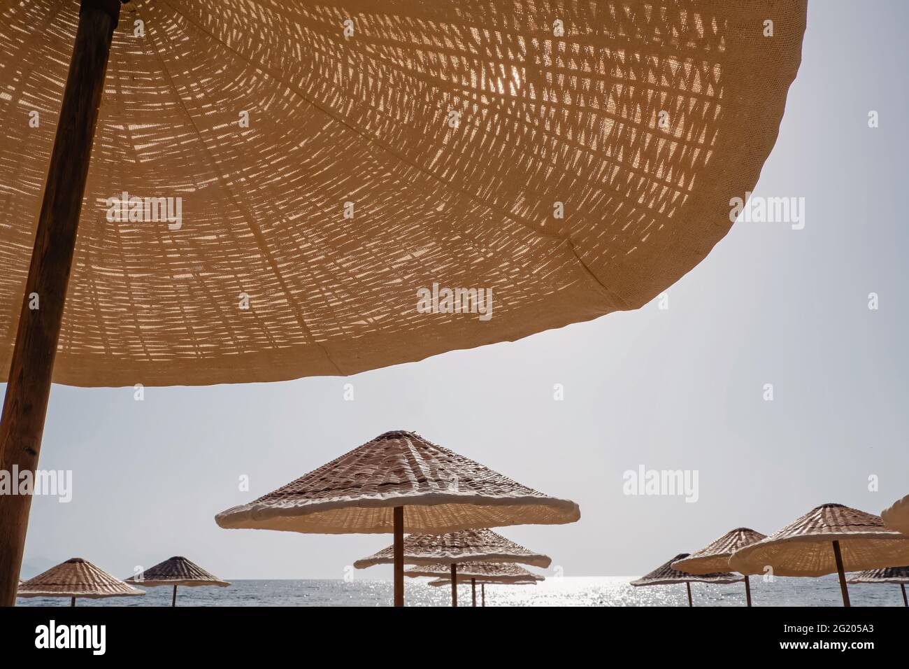 Large umbrella of wicker and cloth Stock Photo - Alamy