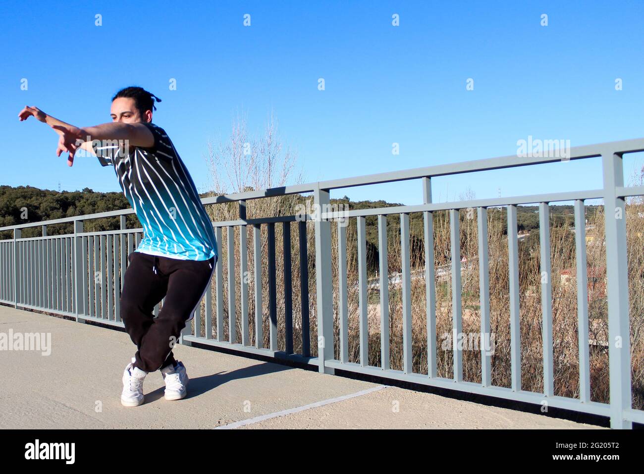 Young hip urban male breakdancing on a sunny bridge Stock Photo - Alamy