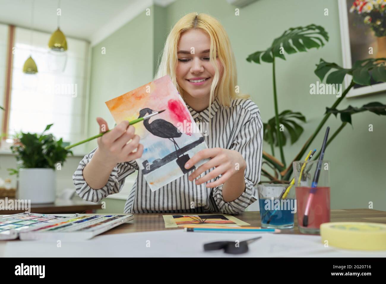 Teenage girl recording video drawing lesson, watching and showing ...