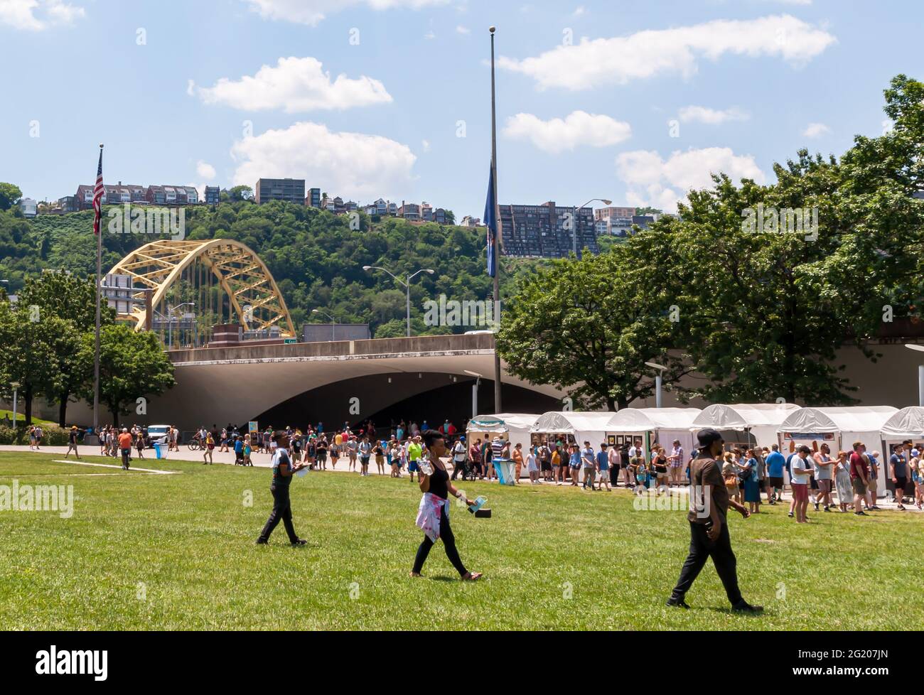 People walking across a field at the Three Rivers Arts Festival in ...