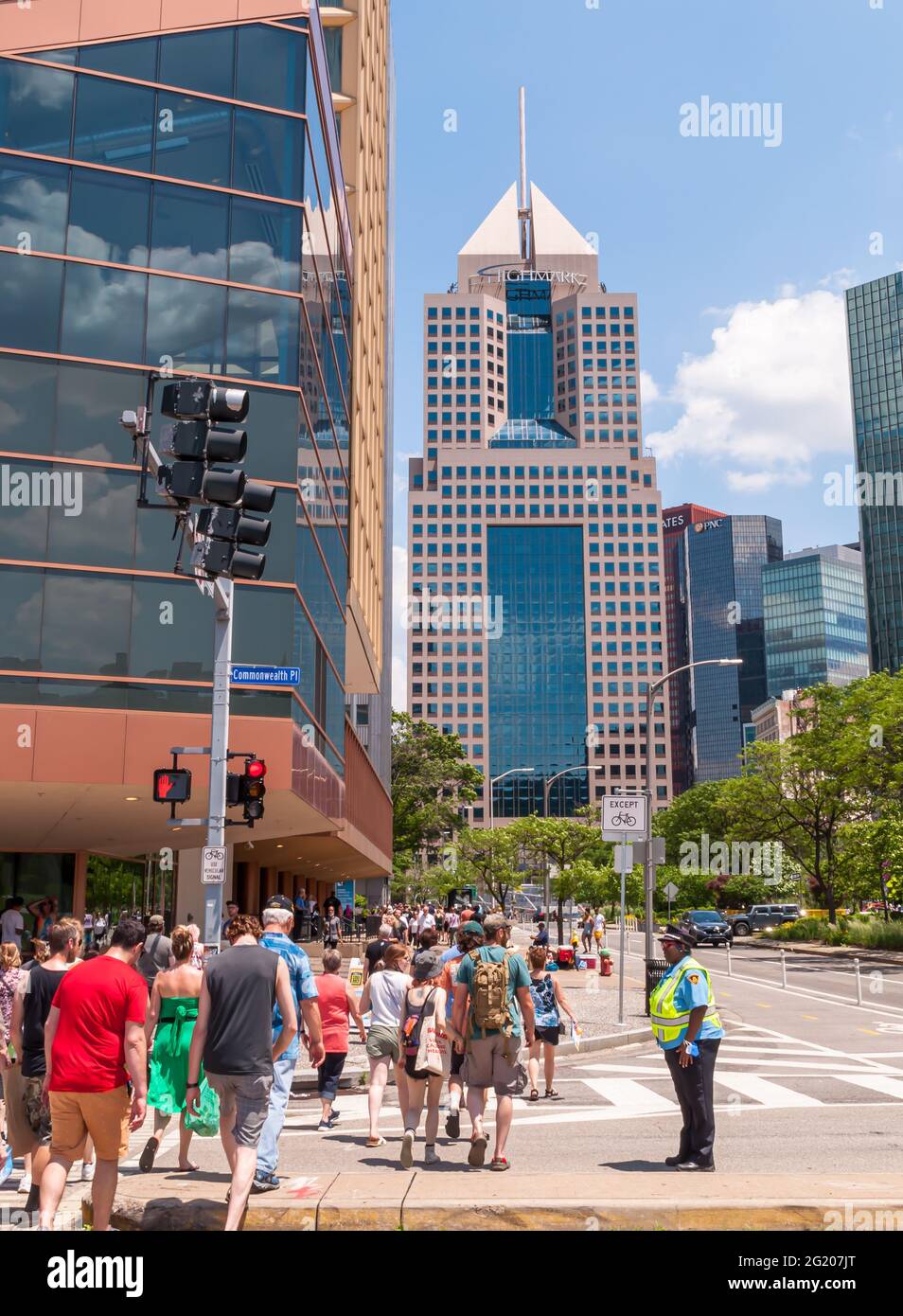 A crossing guard crossing people at the intersection of Liberty ave and ...