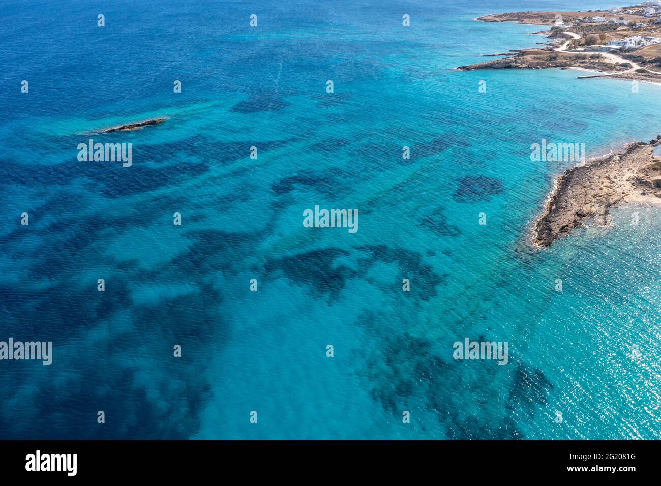 Greece. Small Cyclades seascape. Whitewashed buildings, rocky coastline ...