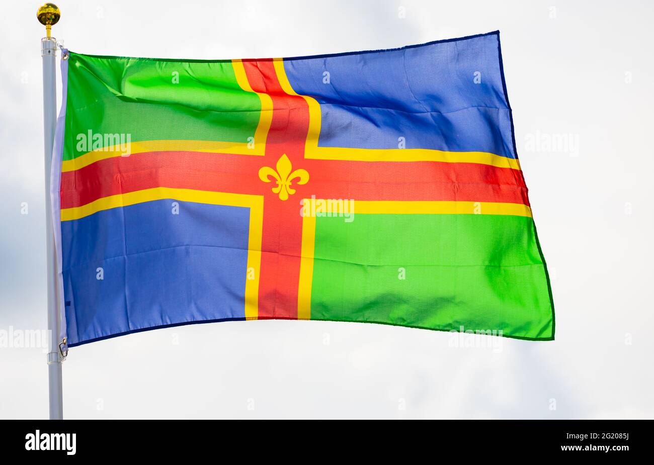The flag of the county of Lincolnshire, flying against a white sky ...