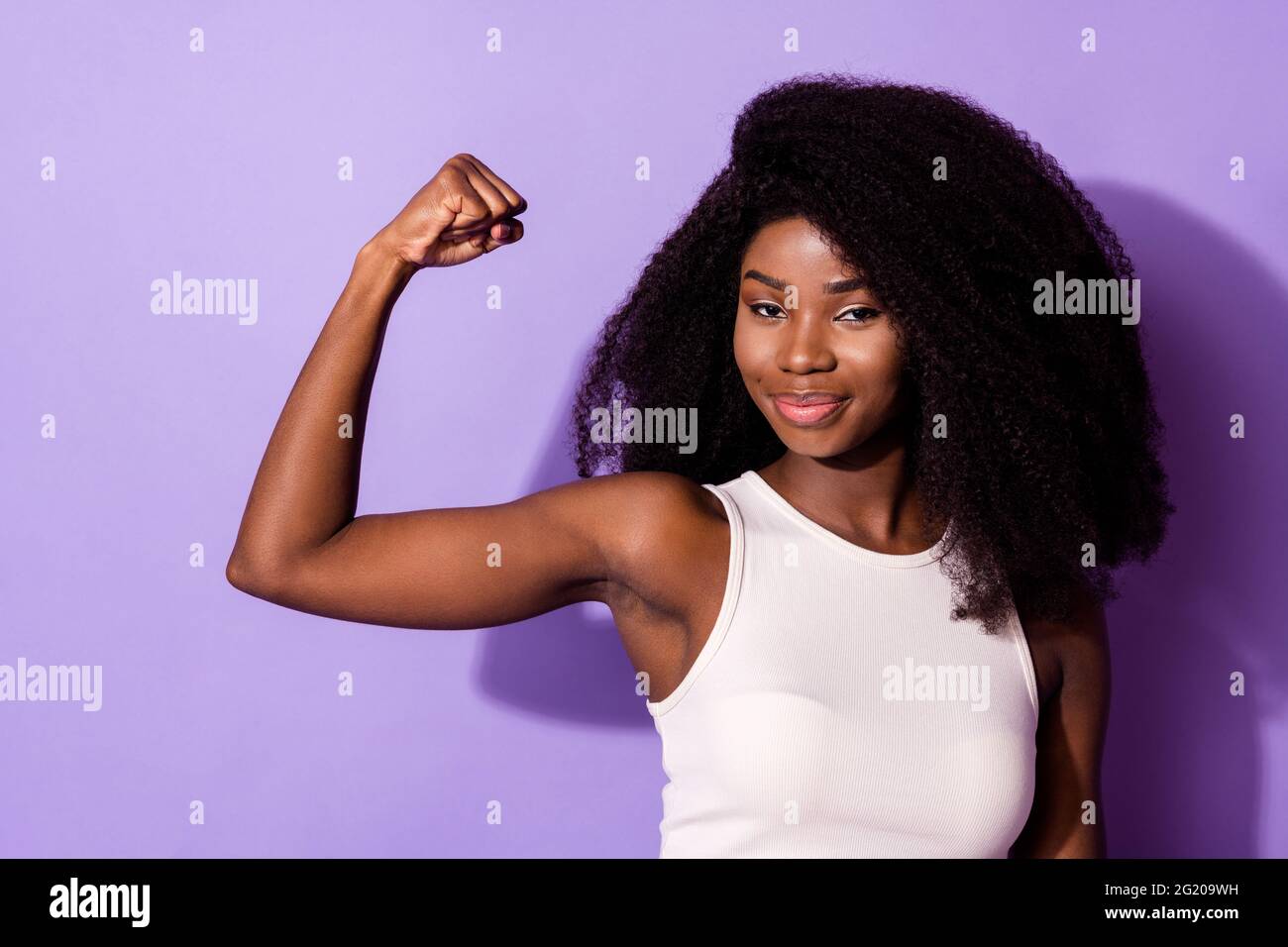 Photo of positive dark skin girl hand flex biceps smile look camera ...