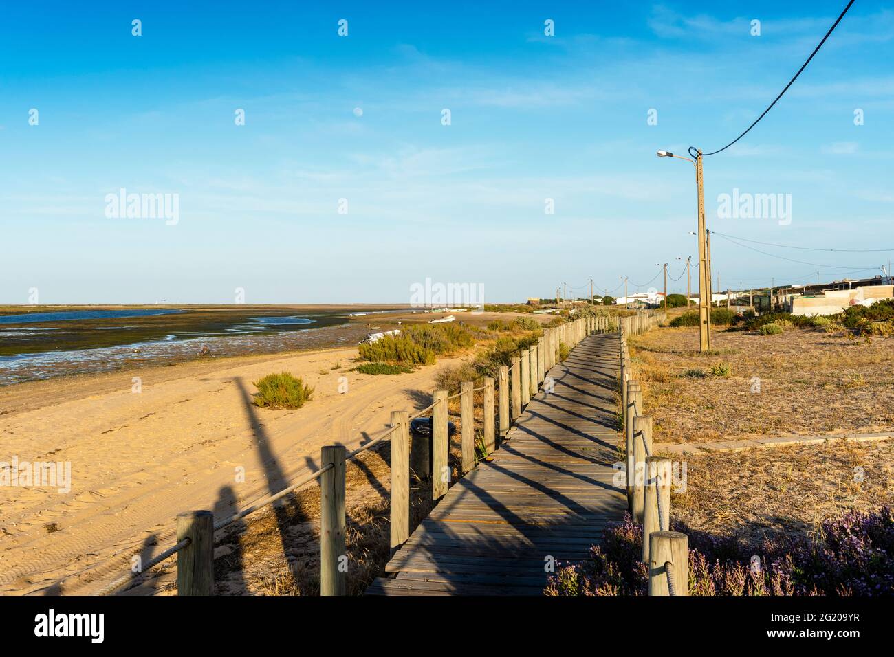 Wooden walkways with view on wetlands of Ria Formosa on Faro Beach ...