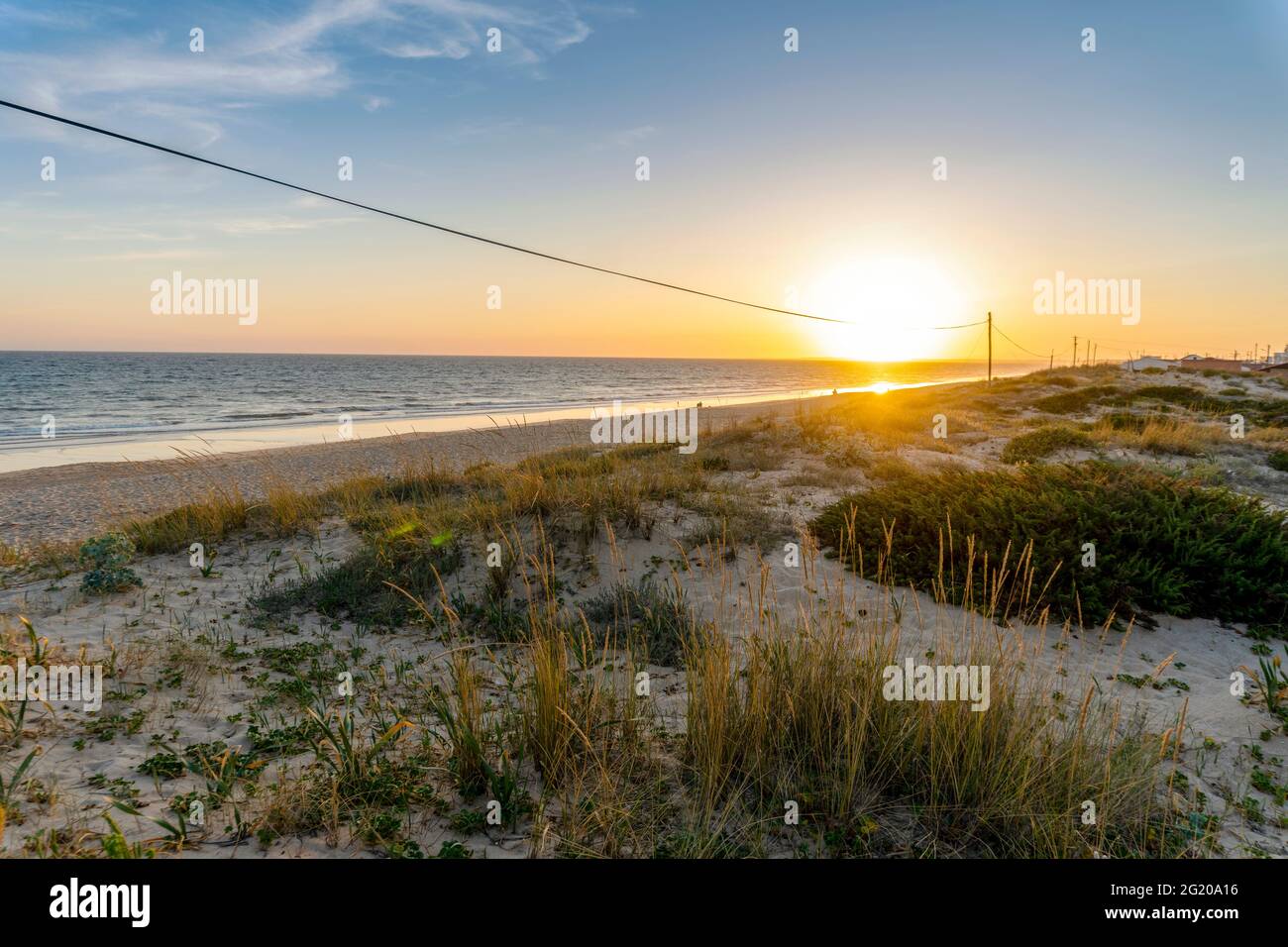 Wide sandy Faro beach with dunes and walkways by the sunset, Faro ...