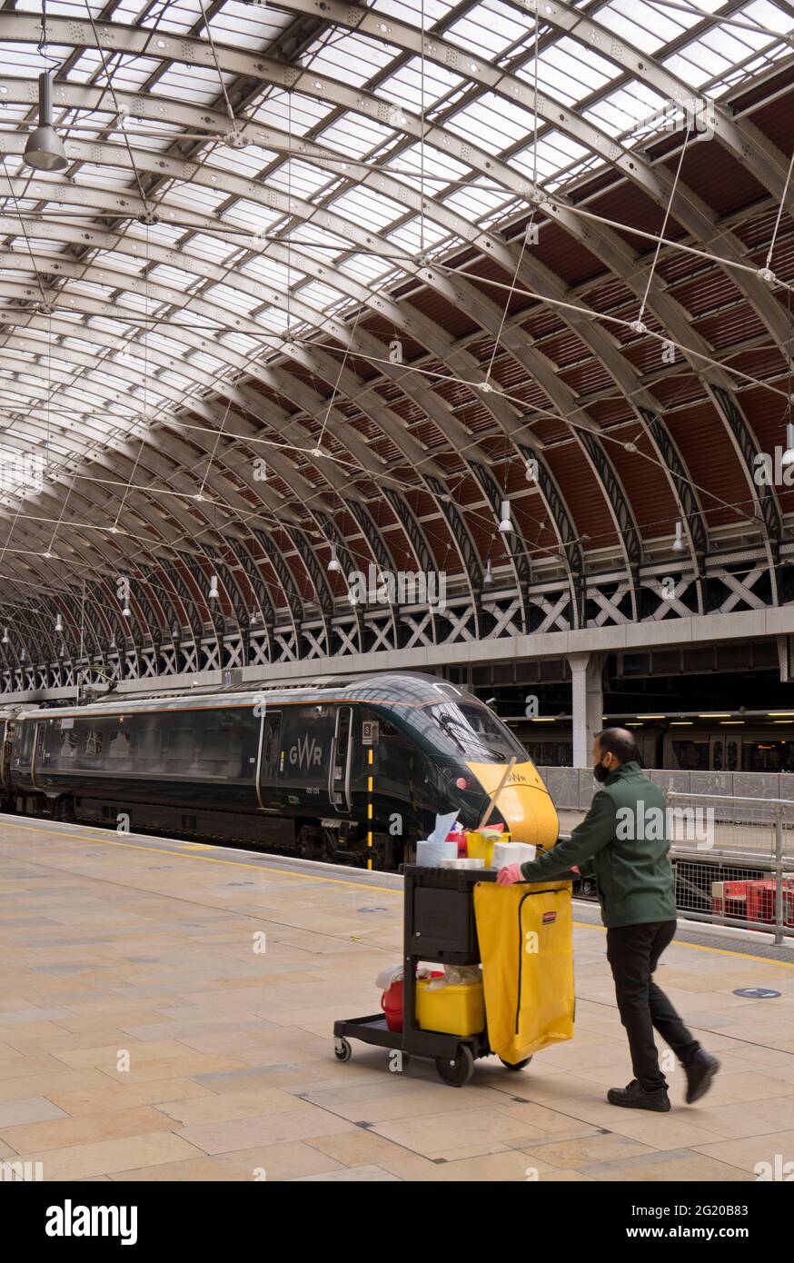 Passengers and staff at Paddington train station in London wearing ...