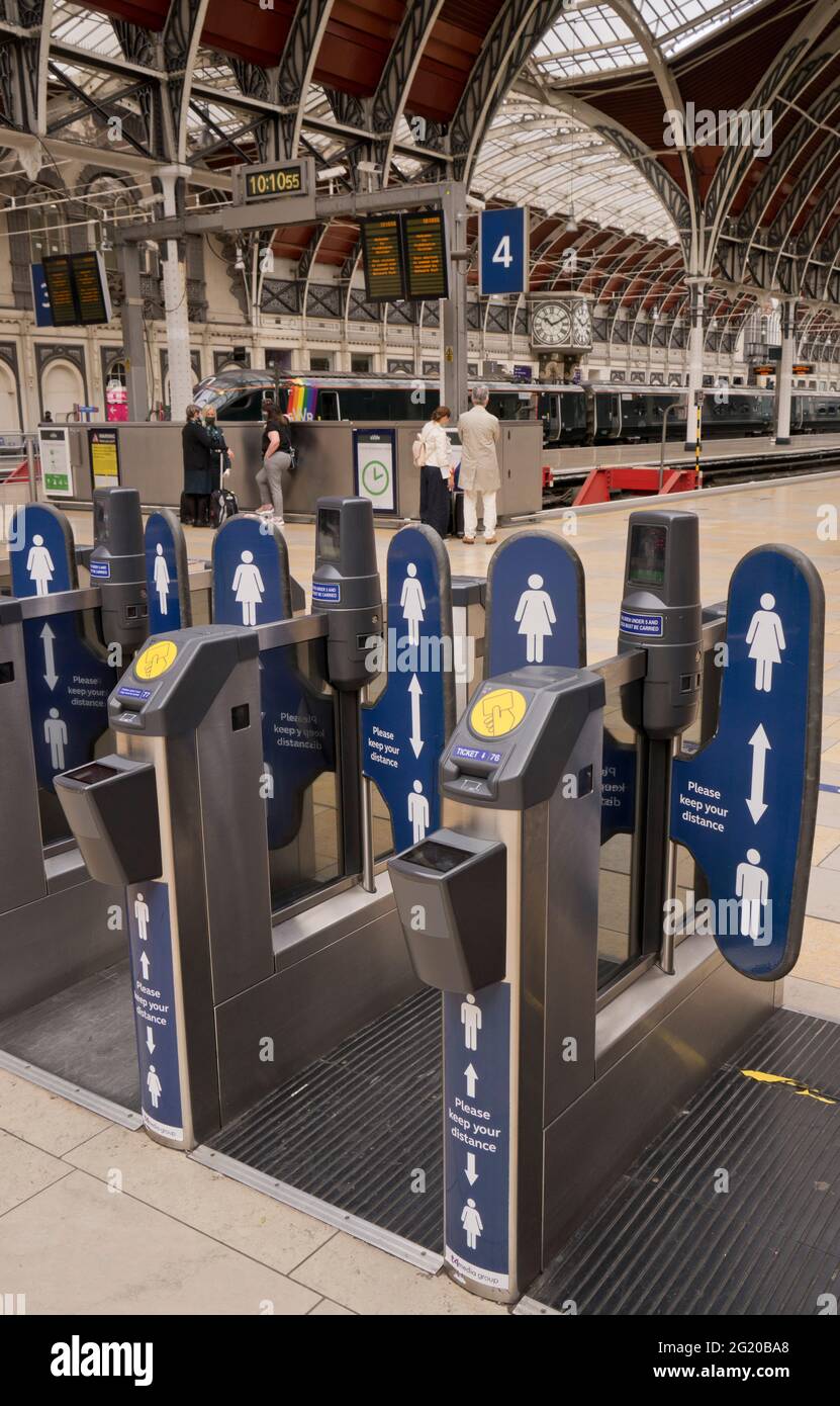 Passengers and staff at Paddington train station in London wearing ...