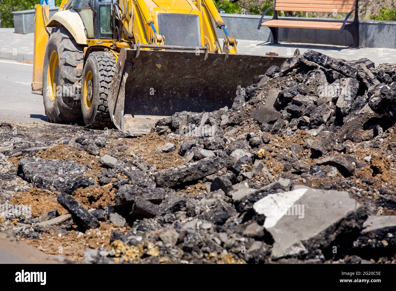 special road machinery a tractor with a bucket removes the remains of ...