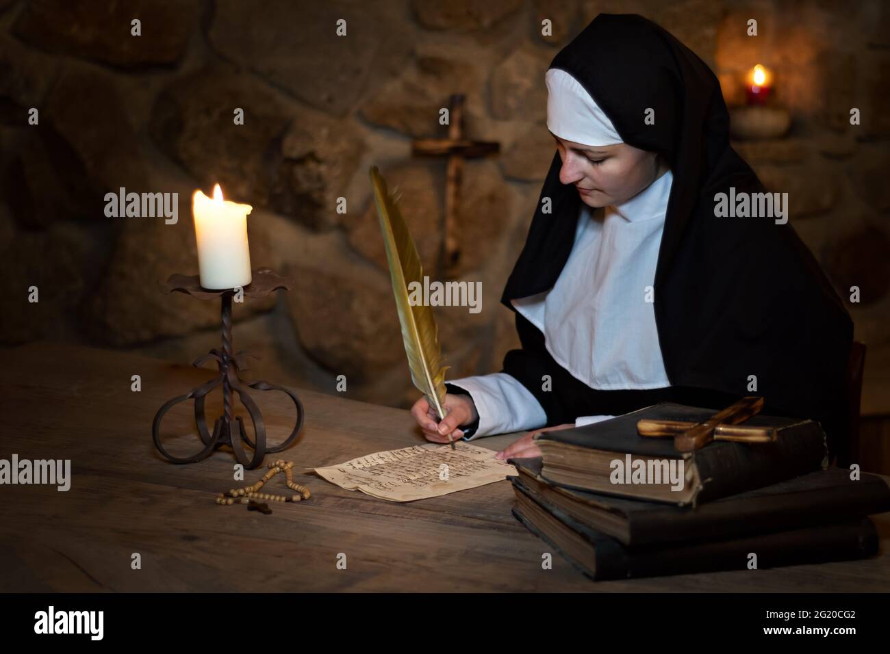 Nun writes an old letter with a quill Stock Photo - Alamy