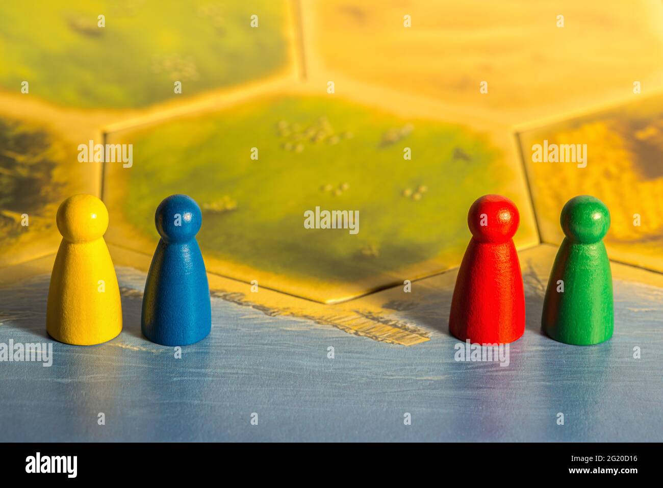 Four different colored chips on yellow game board Stock Photo - Alamy