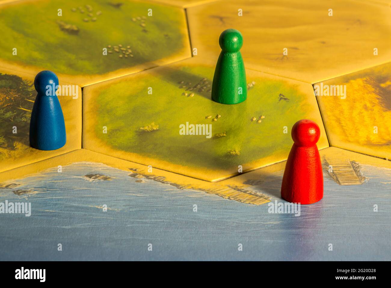 Three different colored chips on game board Stock Photo - Alamy