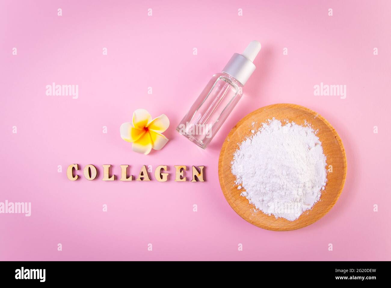 Collagen powder in a wooden bowl and moisturizing cosmetic serum on a ...