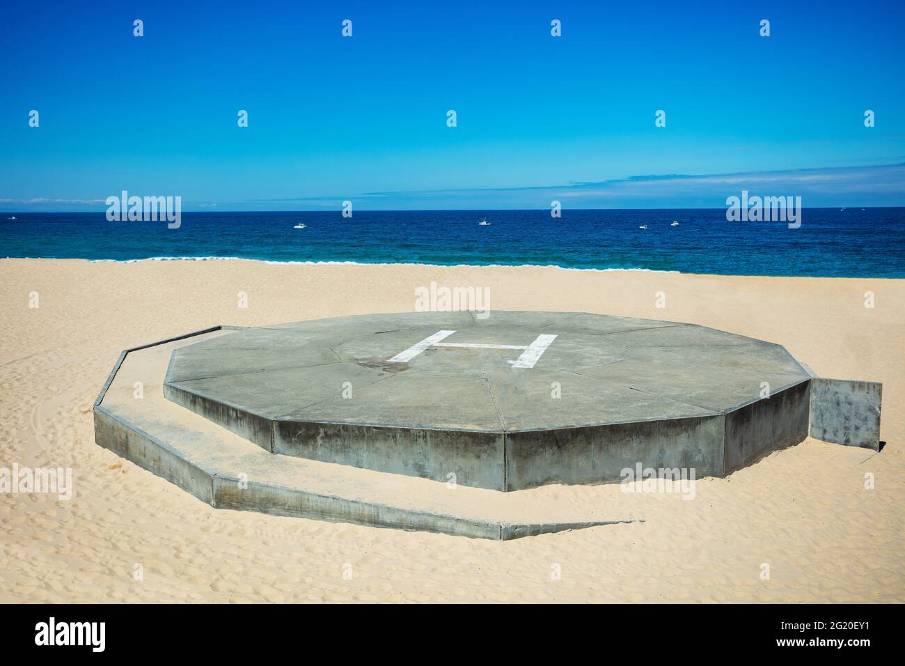 Heliport on the sand beach over blue sea view Stock Photo - Alamy