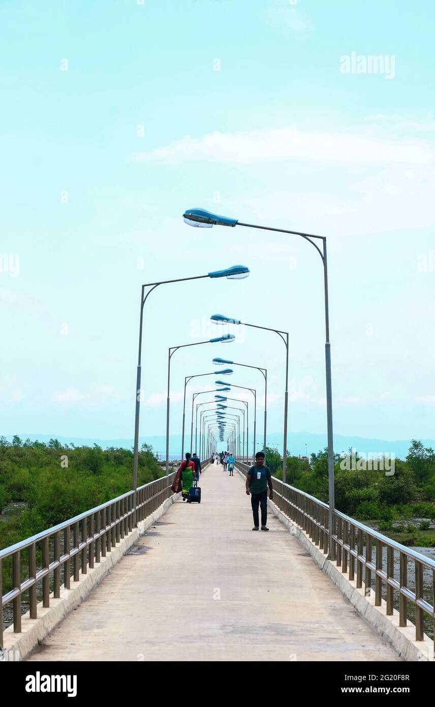 Pier or jetty, footpath promenade, and sea at sunrise. Beautiful view ...