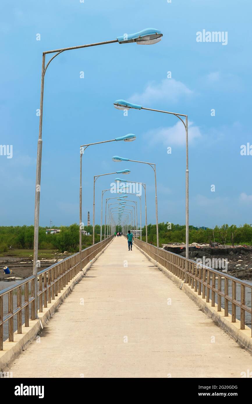 Pier or jetty, footpath promenade, and sea at sunrise. Beautiful view ...