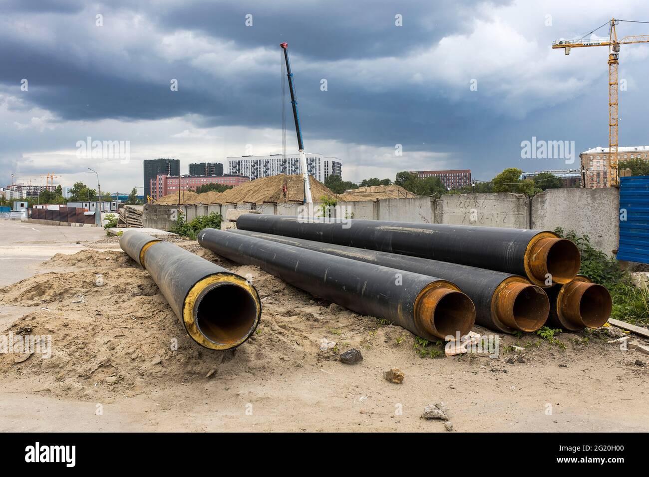 Moscow, Russia - 07 June 2021, Long factory pipes lie on the ground ...