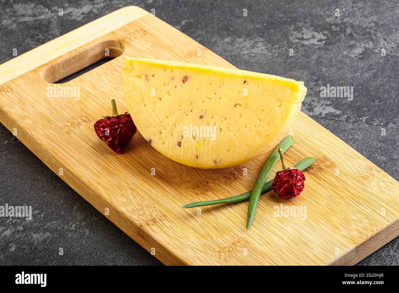 Hard cheese brick with walnut over board Stock Photo - Alamy