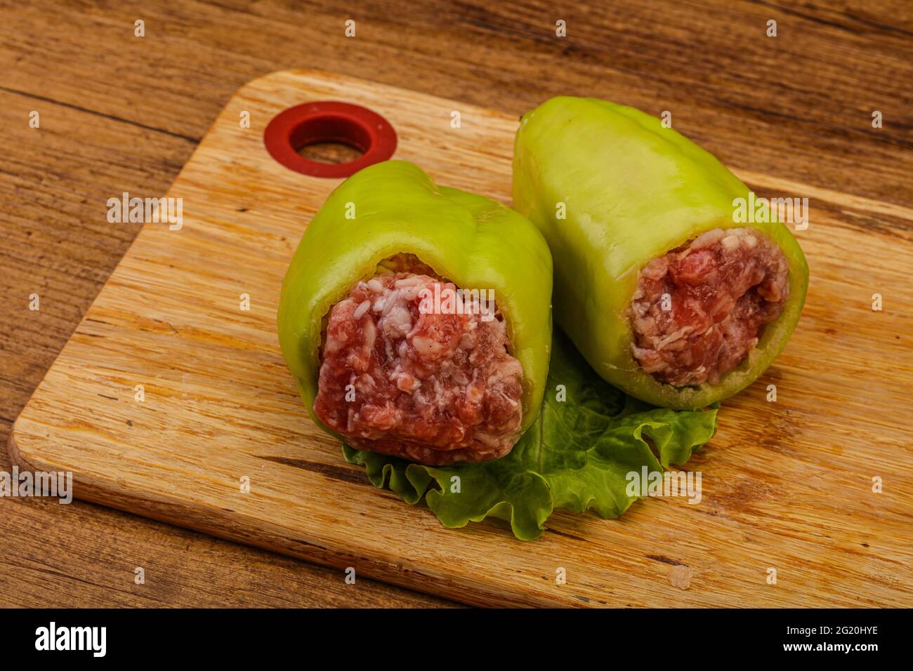 Raw stuffed green bell pepper with meat Stock Photo - Alamy