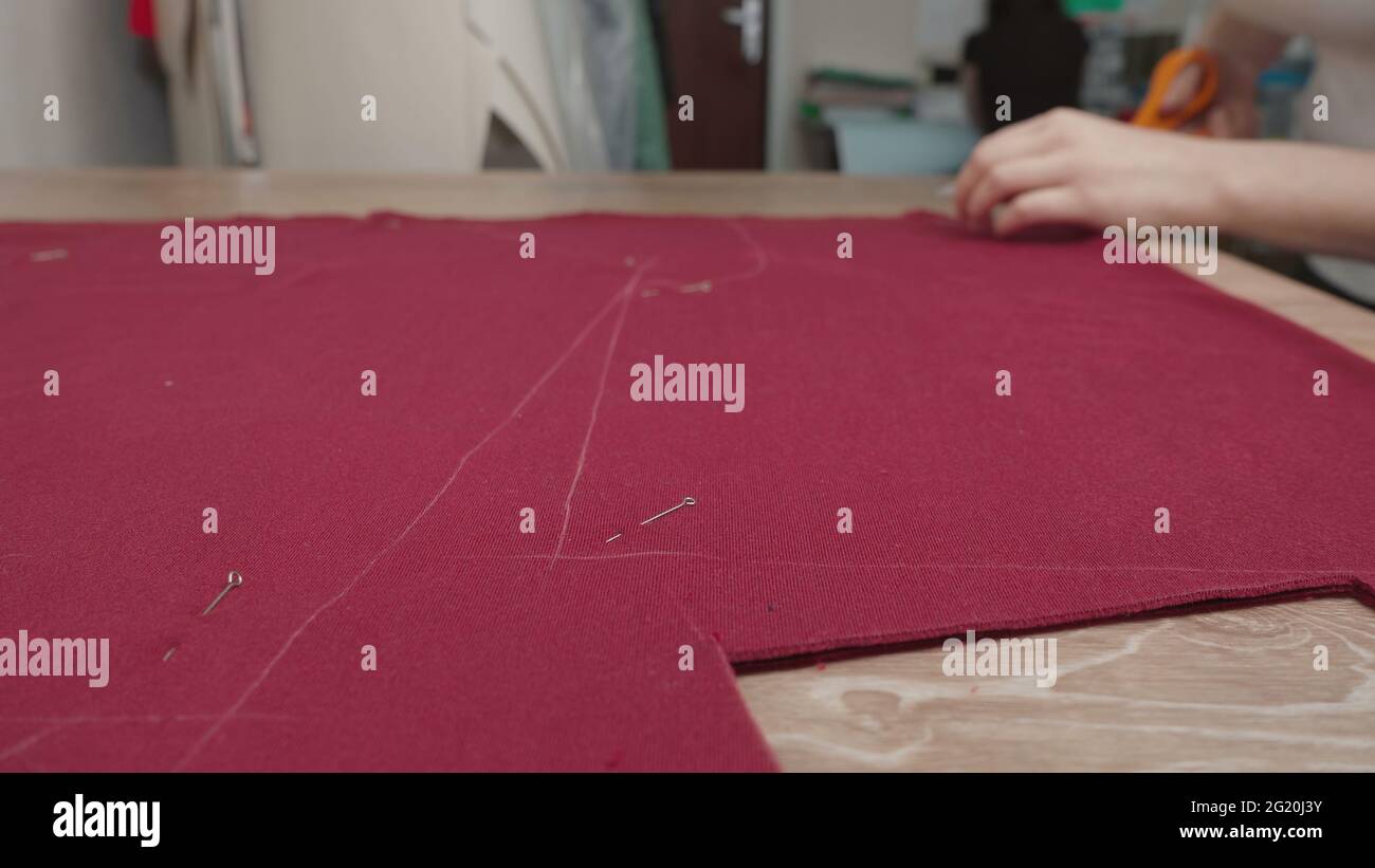 Image of seamstress cutting pattern on fabric in workshop Stock Photo ...