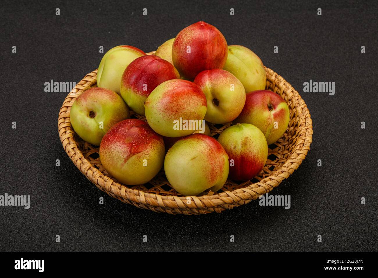 Sweet small green nectarines in the basket Stock Photo - Alamy