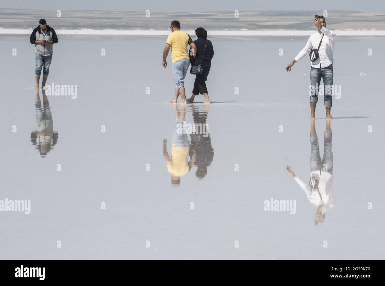 People walk in Salt Lake (Turkish: Tuz Golu), near Cappadocia, Turkey ...