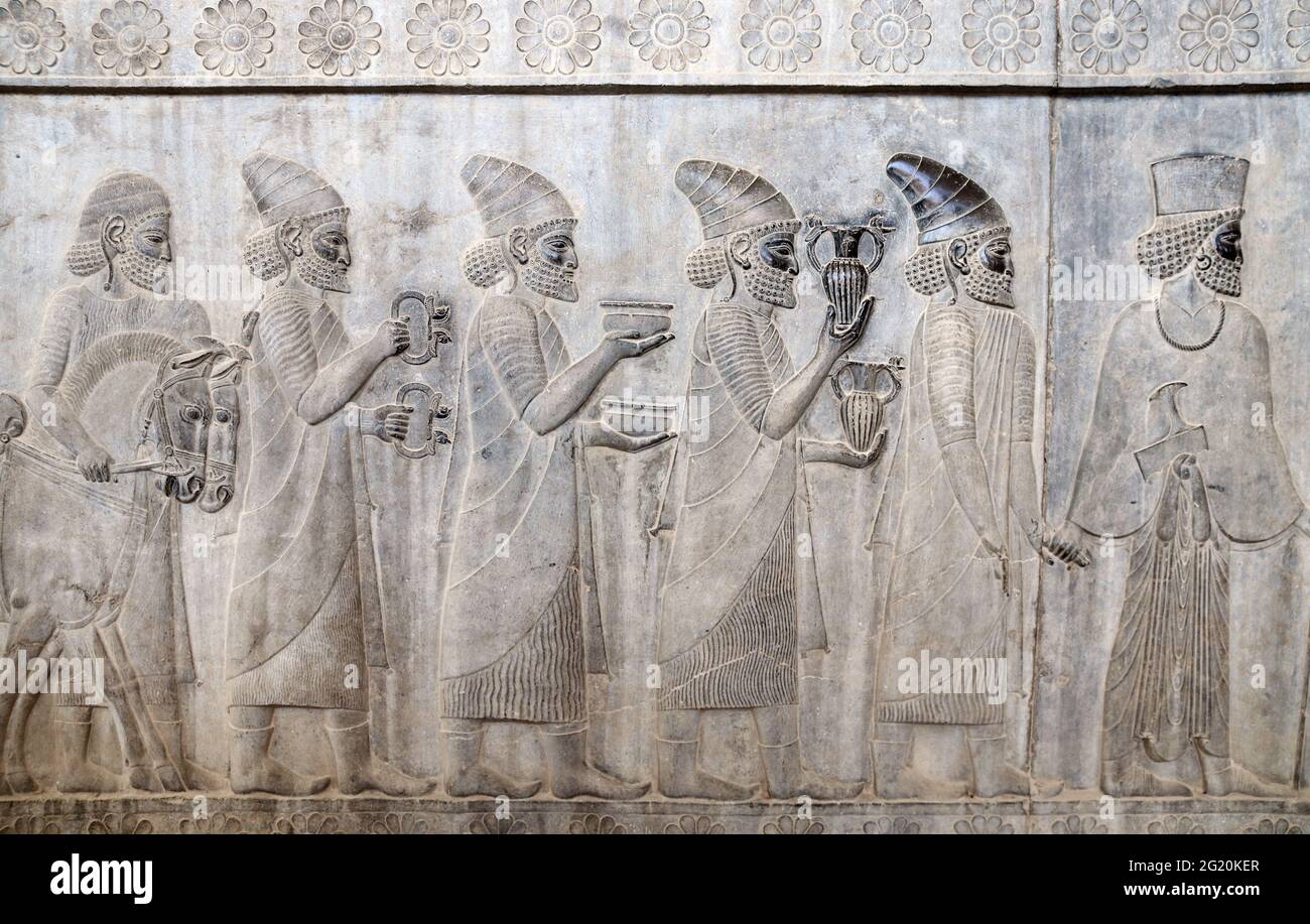 Ancient wall with bas-relief with assyrian foreign ambassadors with ...