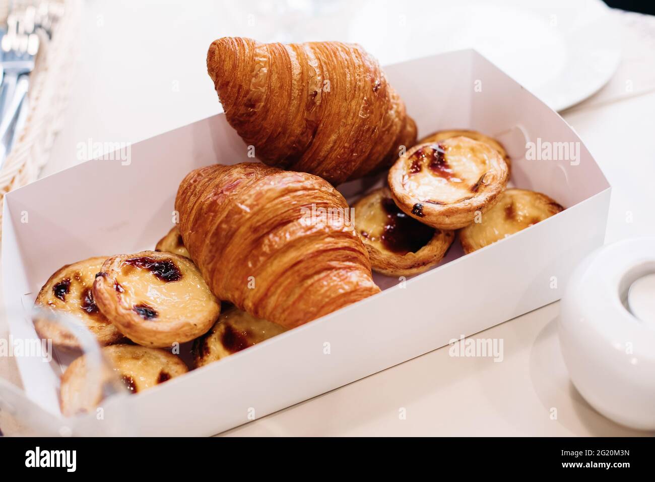 Bakery products, baked sweet croissants, cakes in packaging cardboard ...