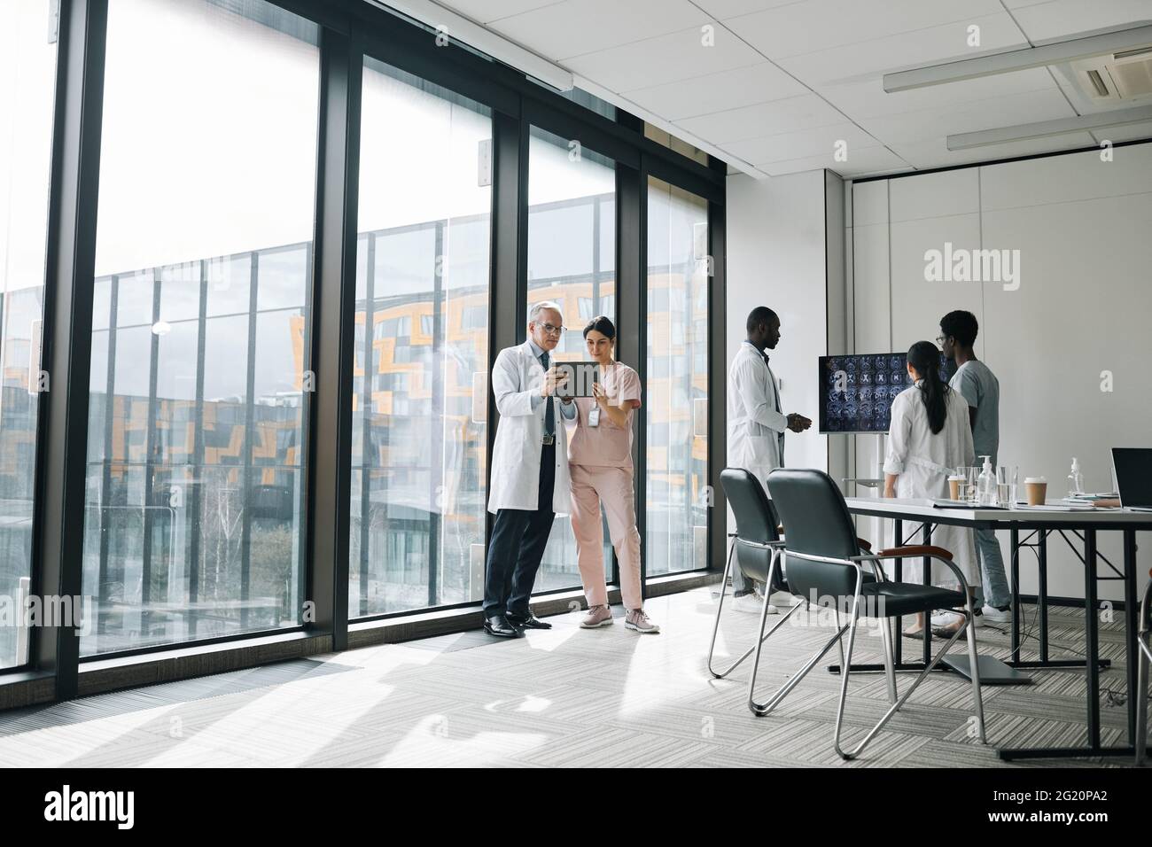 Wide angle view at diverse group of doctors in conference room ...