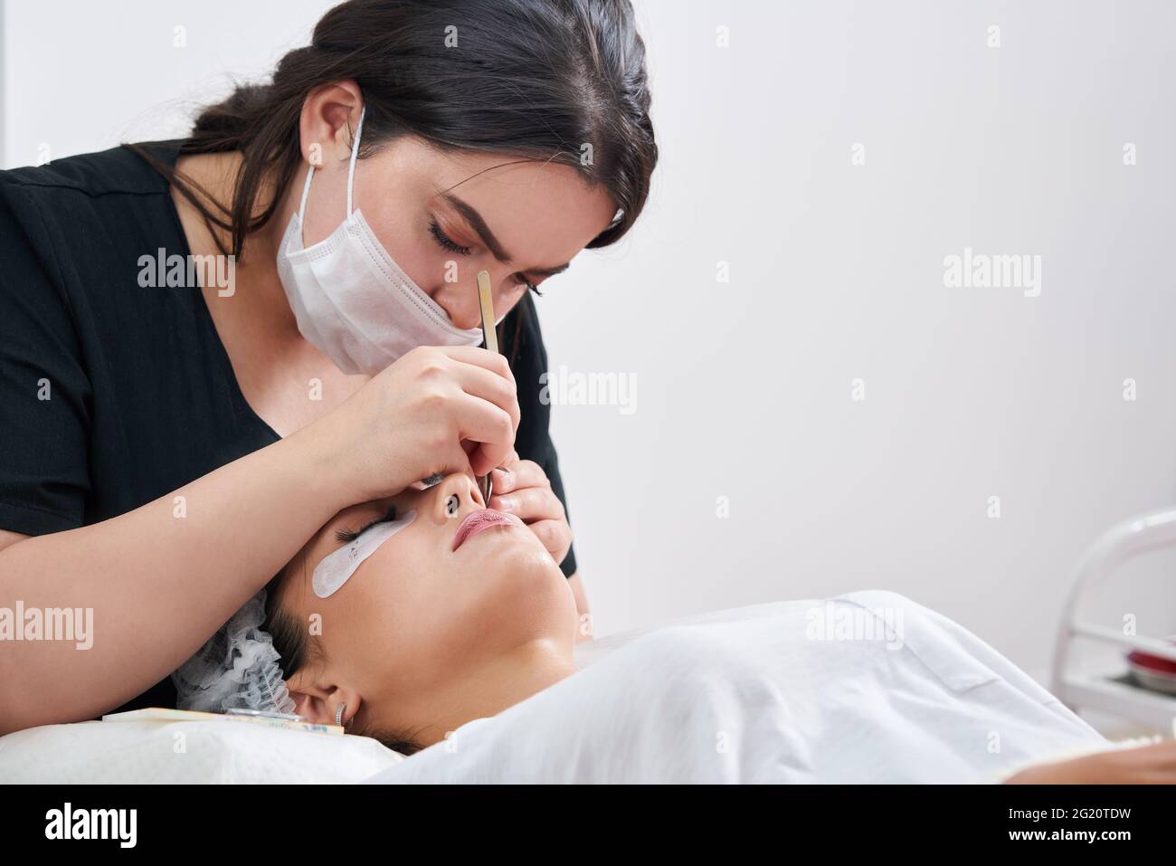 Eyelash Extension Procedure. Woman Eye with Long Eyelashes Stock Photo ...