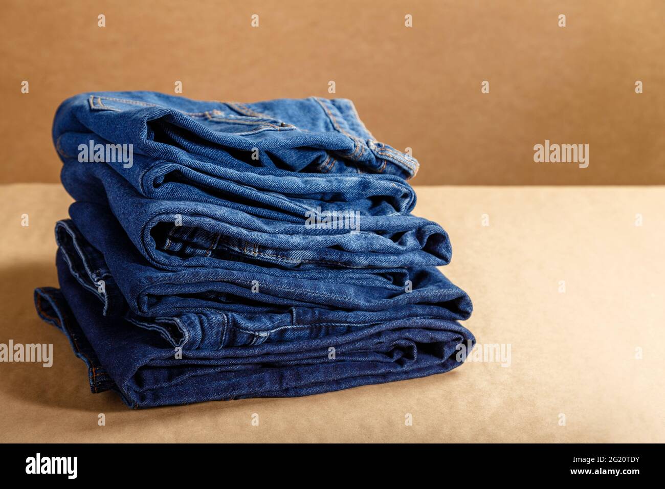Stack of blue denim clothes. Pile folded blue denim pants in different ...