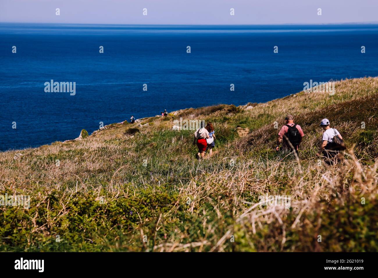 Tourist hikers walking to Hellesveor Cliff, Cornish coastal walk, St ...
