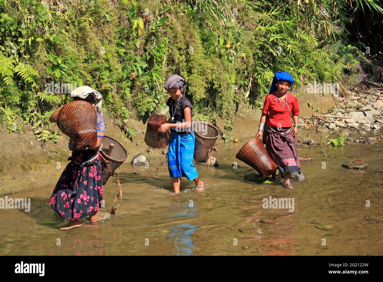 Women from an ethnic community catching fish with traditional fishing ...