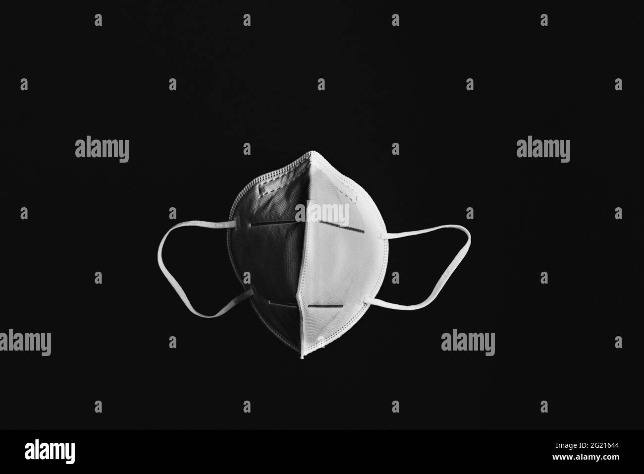 Black and white photo of front side of KN95 mask isolated on black ...