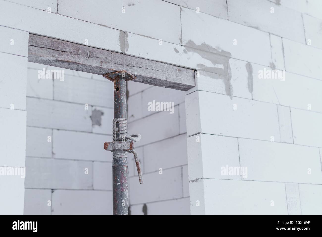 The construction strut supports the cinder block while it solidifies in ...