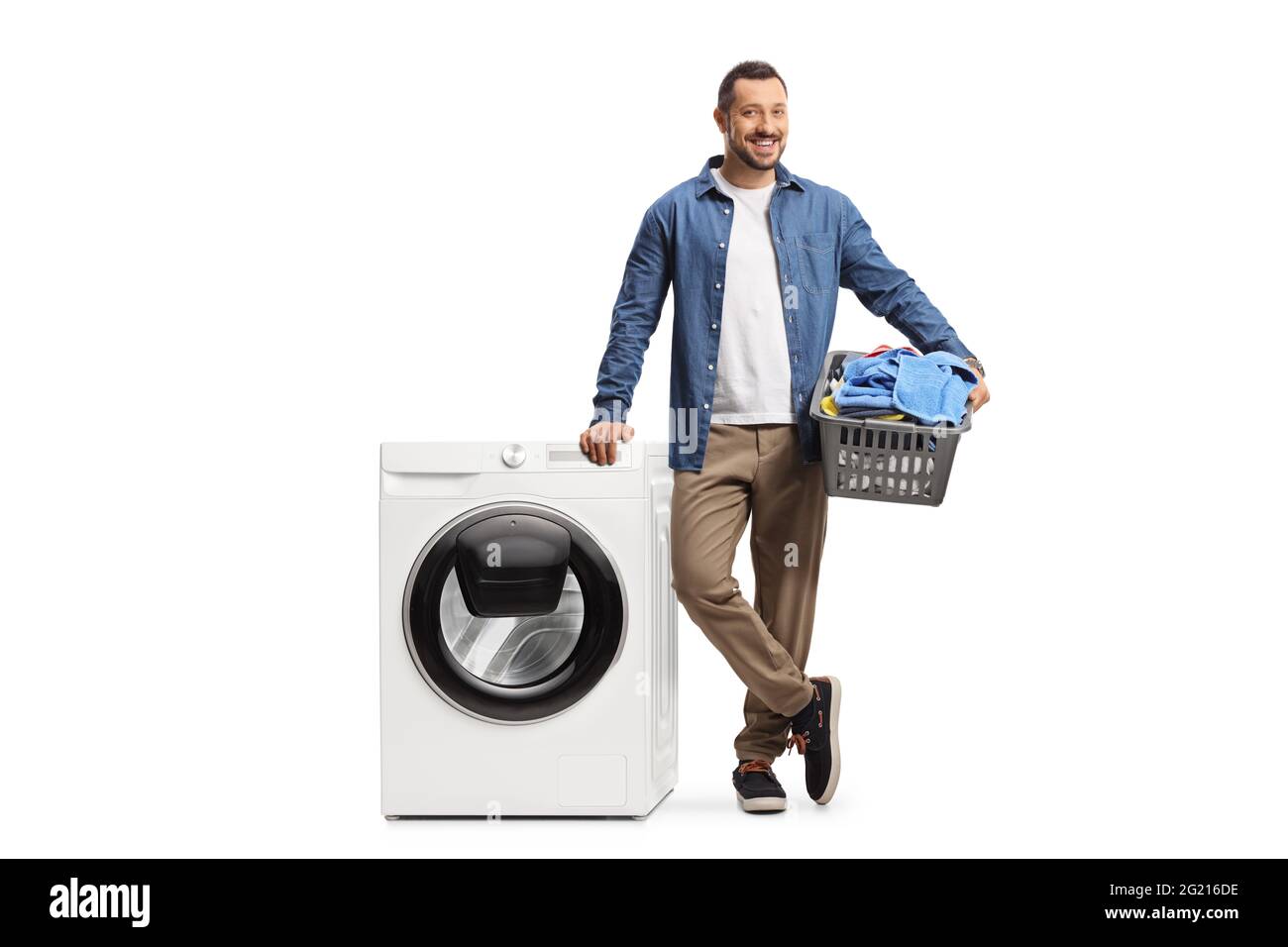 Casual young guy with a laundry basket and a washing machine isolated ...