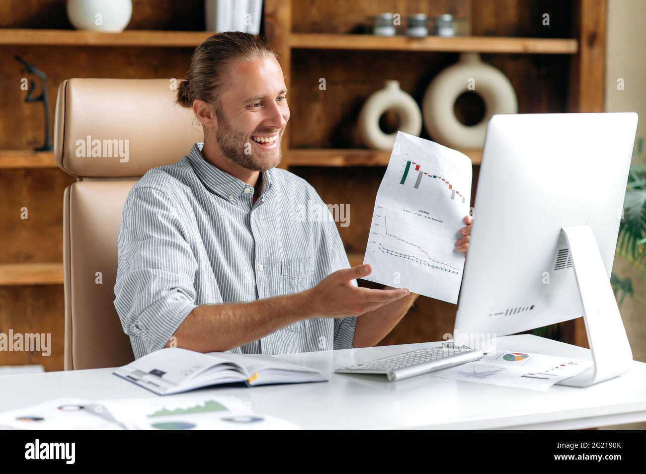 Smart successful young caucasian businessman or CEO with beard sitting ...