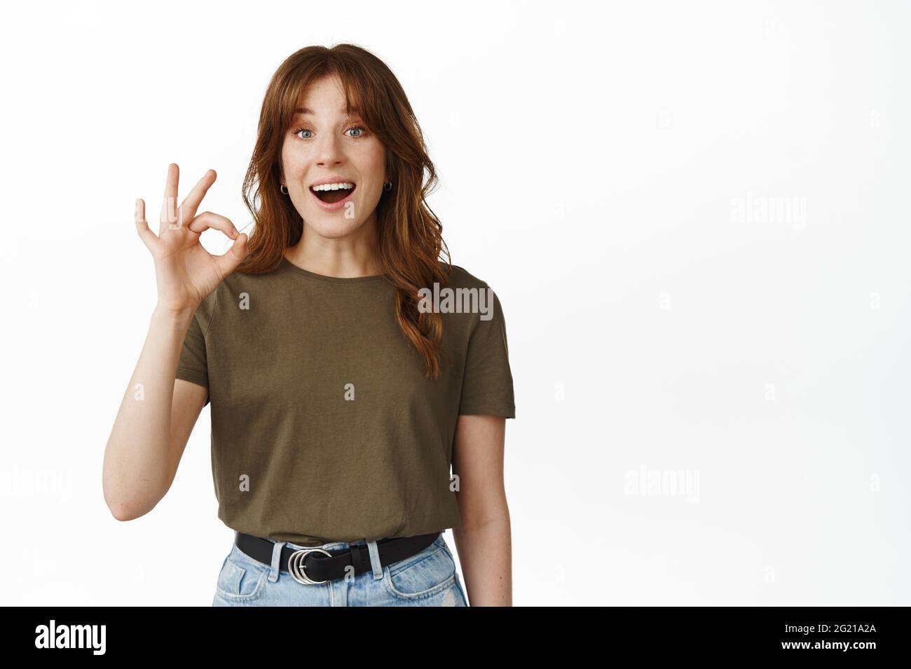 Very good, awesome. Smiling happy girl showing OK okay sign, say yes ...
