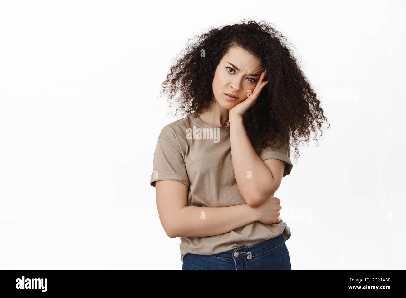 Sulking young woman lean on hand and looking with angry annoyed face at ...