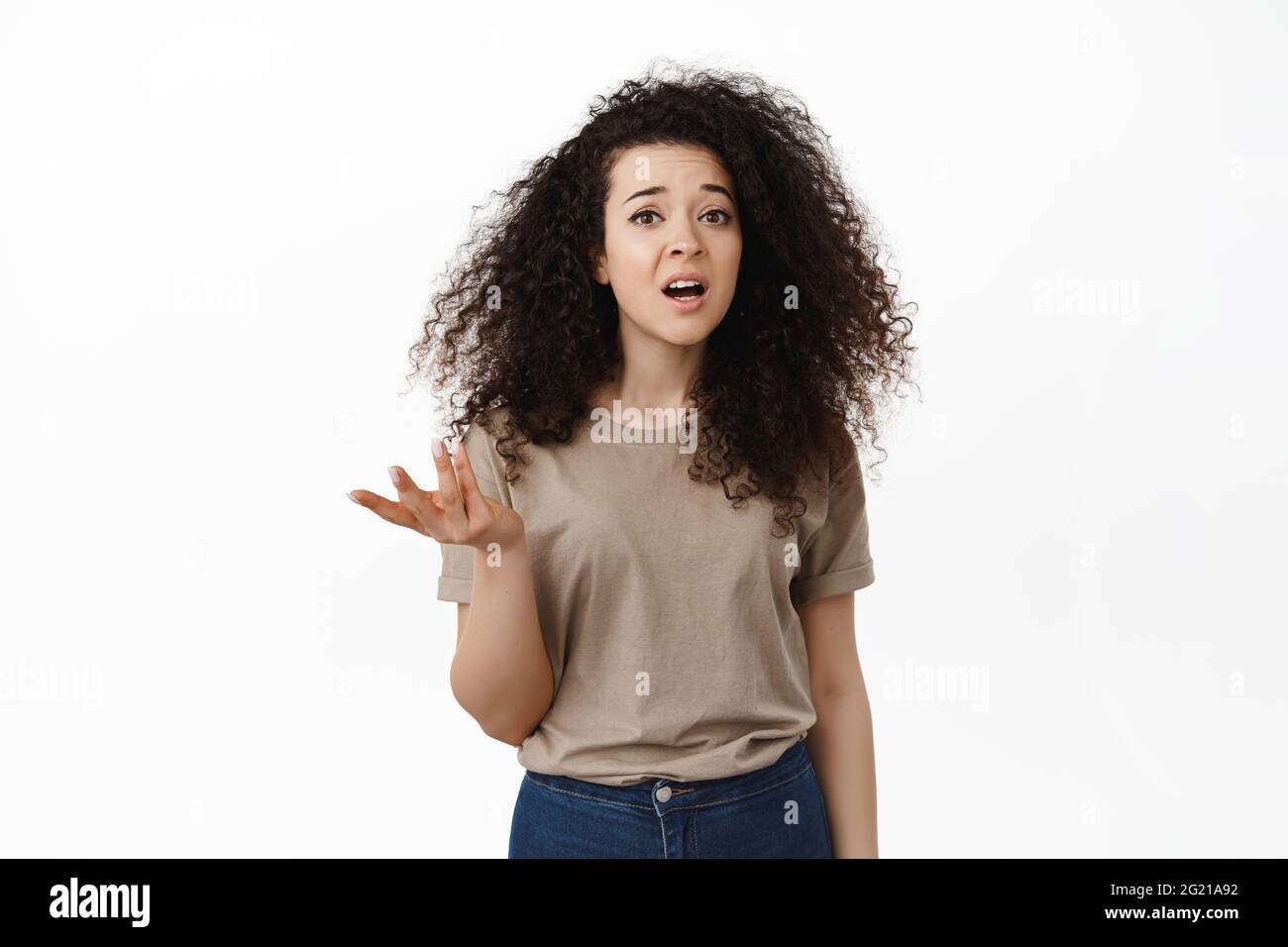 Confused brunette woman shrugging, looking clueless and puzzled, dont ...