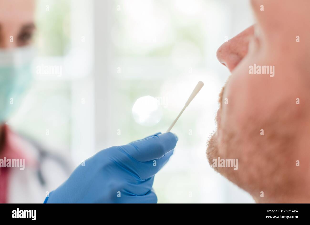 Doctor inserting swab in patients nose for Covid 19 test Stock Photo ...