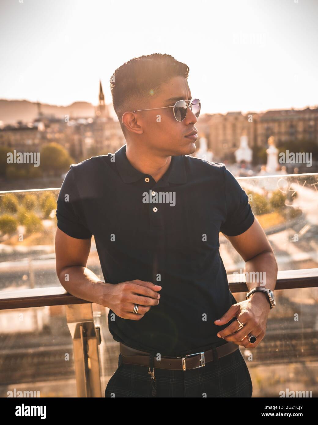 Handsome Hispanic guy in sunglasses on a balcony Stock Photo - Alamy