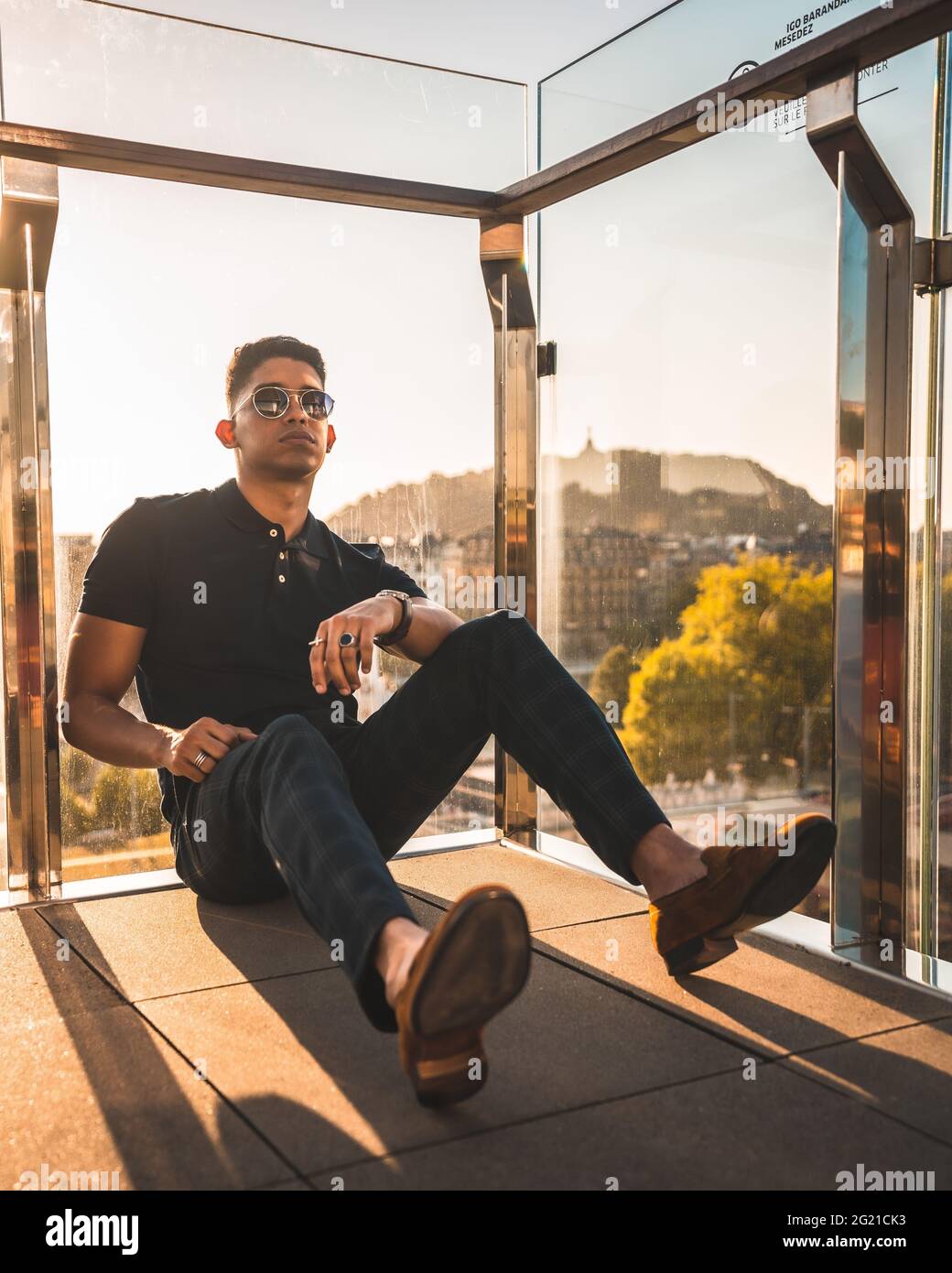 Guy sitting in balcony hi-res stock photography and images - Alamy